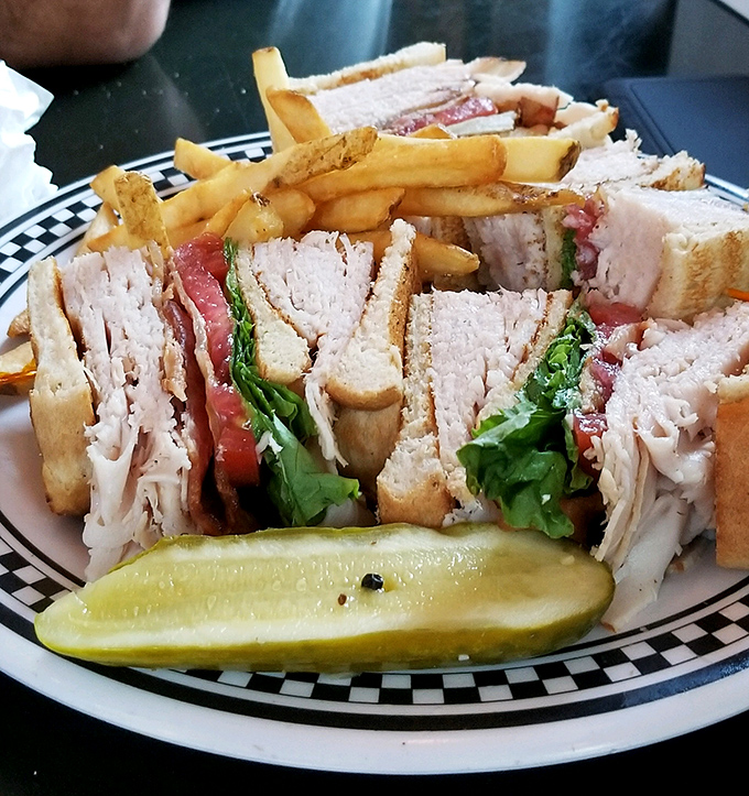 This club sandwich isn't just stacked &ndash; it's architected. With layers that would make Frank Lloyd Wright proud and a pickle that means business.