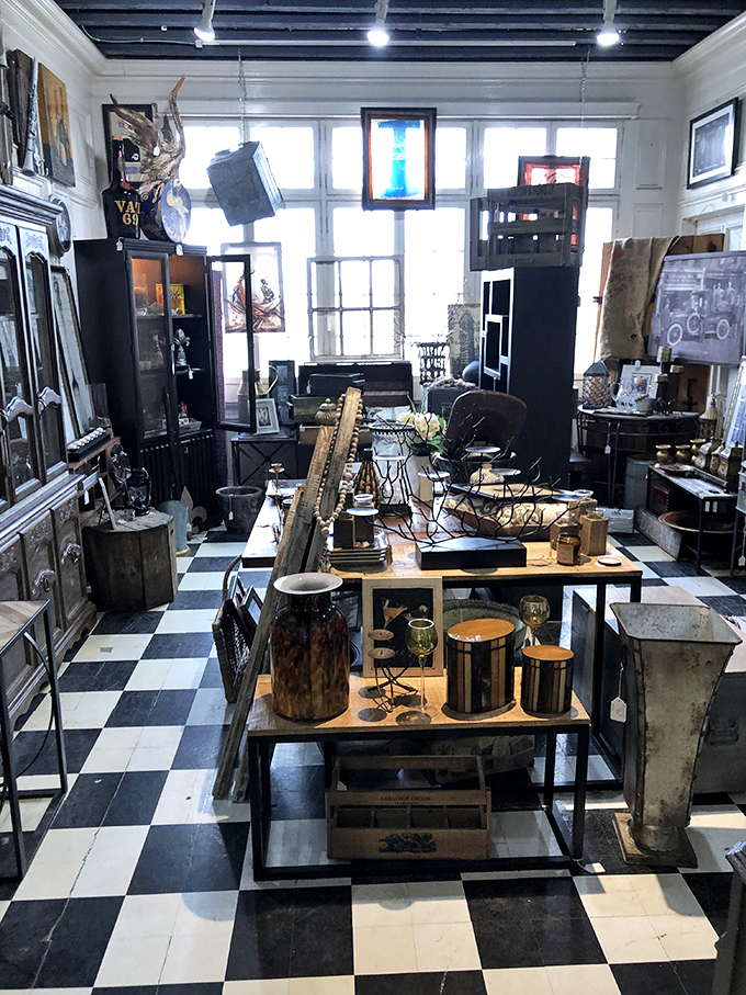 This black-and-white tiled vendor space feels like stepping into a Wes Anderson film set. Industrial-chic meets carefully curated chaos.