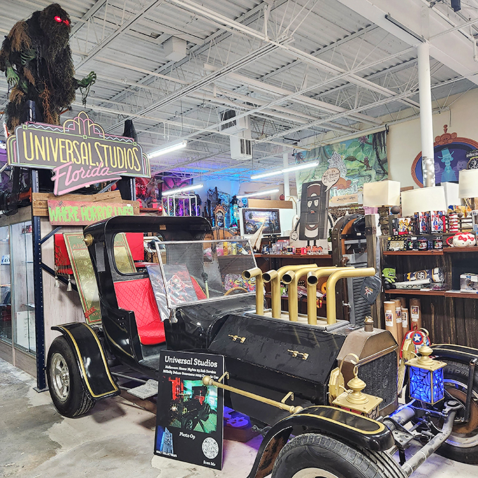 A vintage Universal Studios ride car sits proudly among theme park memorabilia. Once carrying tourists through movie magic, now it's the star attraction in this nostalgic Hollywood corner.