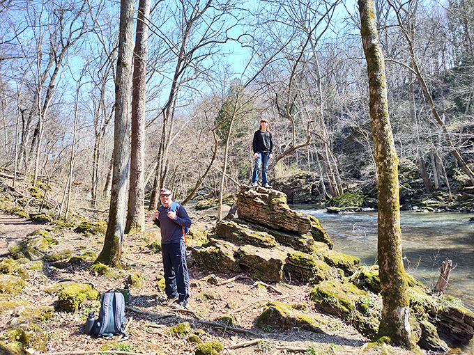 Explorers stake their claim on riverside rocks, proving adventure doesn't require a passport—just comfortable shoes and curiosity.