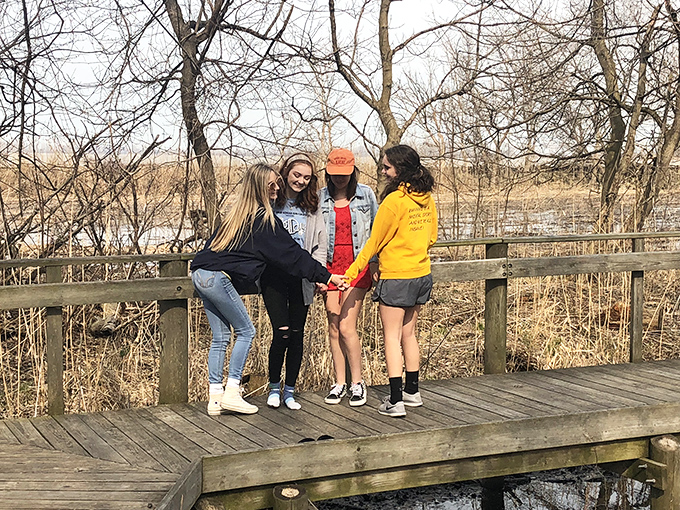 Friends finding joy on the boardwalk observation deck – where memories are made one laugh at a time.