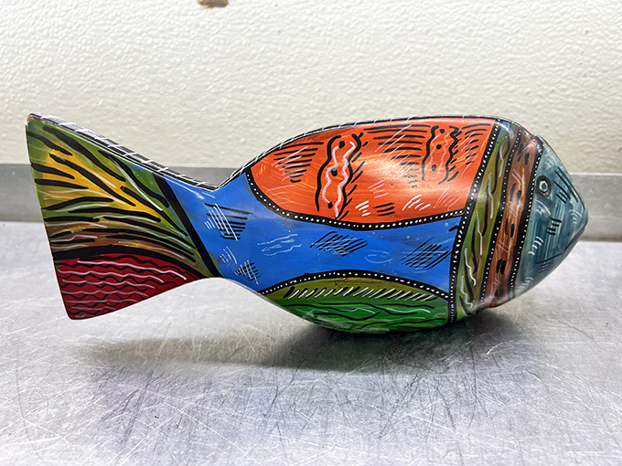Swimming against the current of mass-produced decor, this vibrant wooden fish brings artisanal charm to any room. No feeding required.
