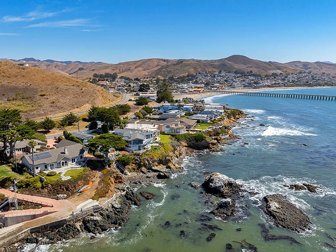 Cayucos pier extends into Pacific swells where fishing lines dance and surfers catch perfect waves in this unspoiled gem.