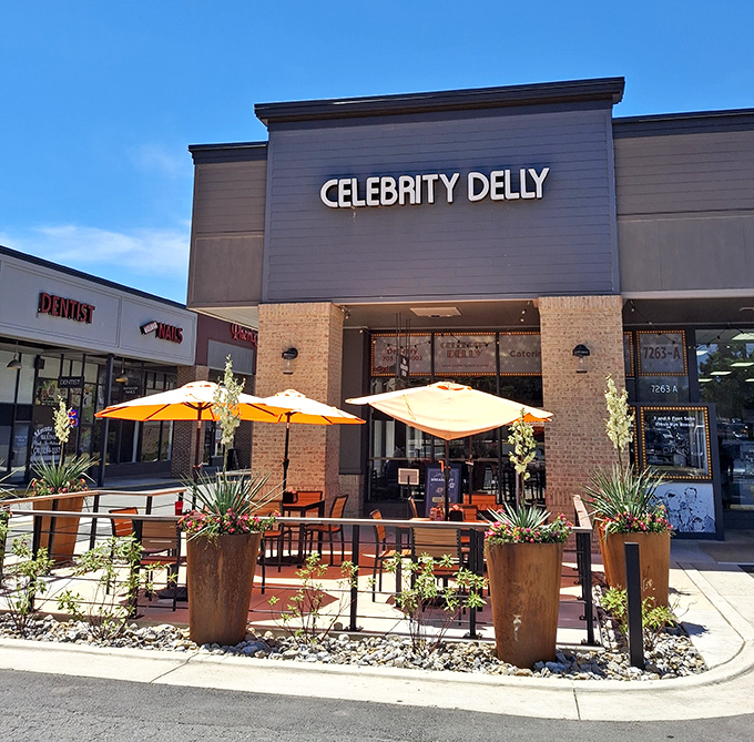 Celebrity Delly's outdoor seating area looks like the perfect spot for a sandwich vacation. Those orange umbrellas are calling your name!