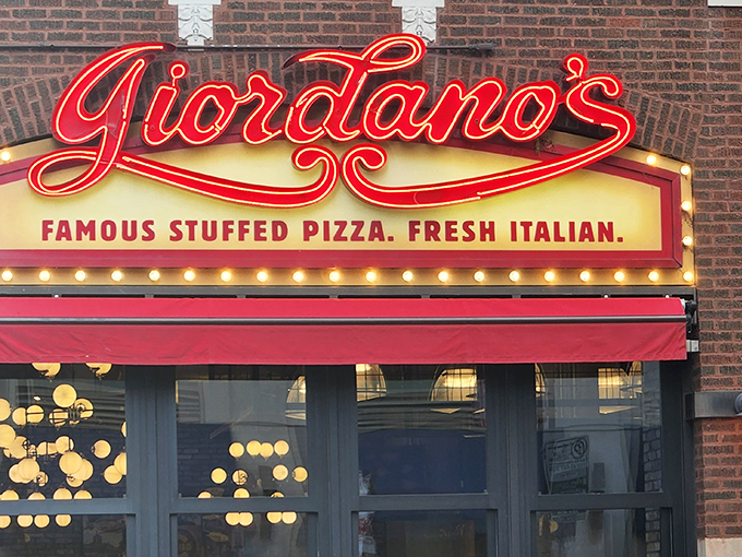 Giordano's glowing sign beckons like a lighthouse for hungry souls seeking stuffed pizza salvation in the urban wilderness.