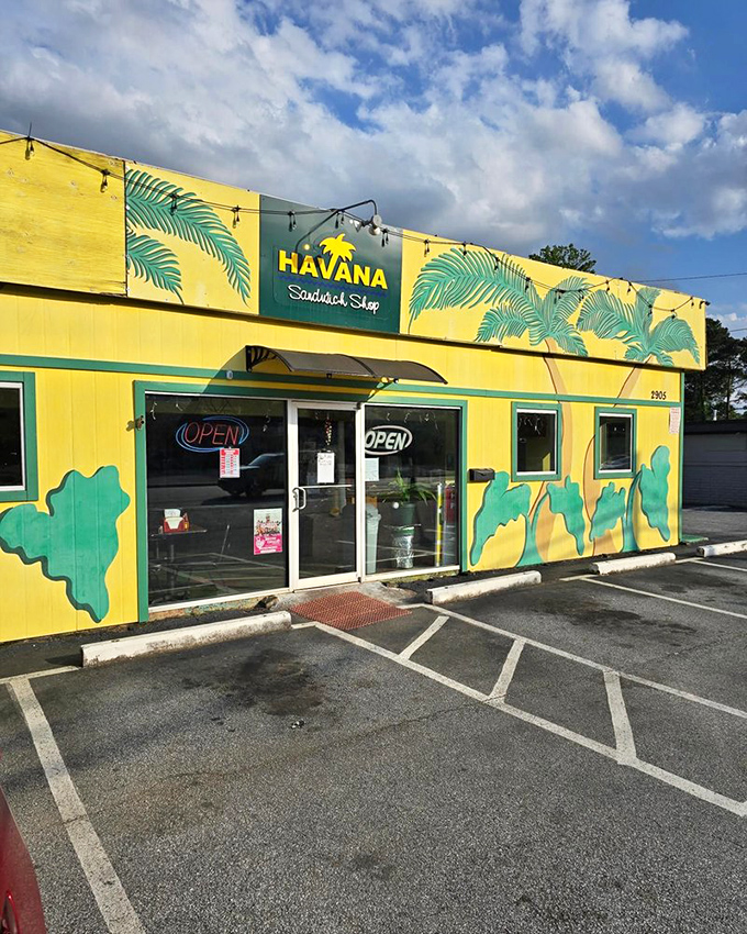 That sunshine-yellow building with palm fronds is like Cuba's cheerful postcard to Georgia! Havana's vibrant exterior promises tropical flavors that'll make your taste buds salsa.