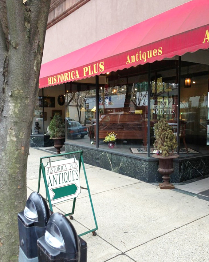 Historica Plus announces itself with a bold red awning, a cheerful beacon for those seeking memories wrapped in vintage packaging.