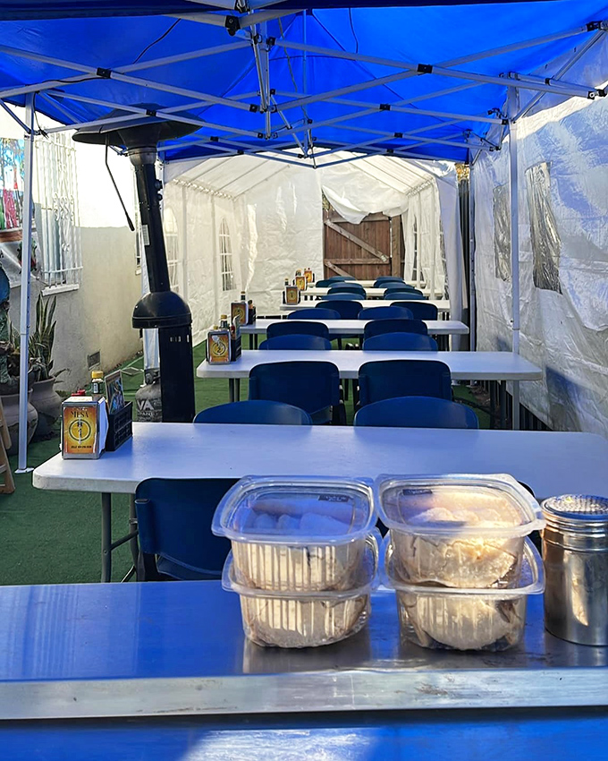 Under blue tarps and string lights, Mariscos El Tambo transforms parking lots into seafood paradise daily.