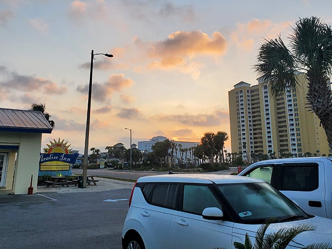Sunset paints the sky while coastal towers stand sentinel over paradise found.