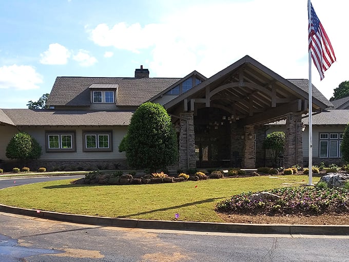The lodge-style clubhouse proudly flies the American flag, promising both community spirit and afternoon card games.