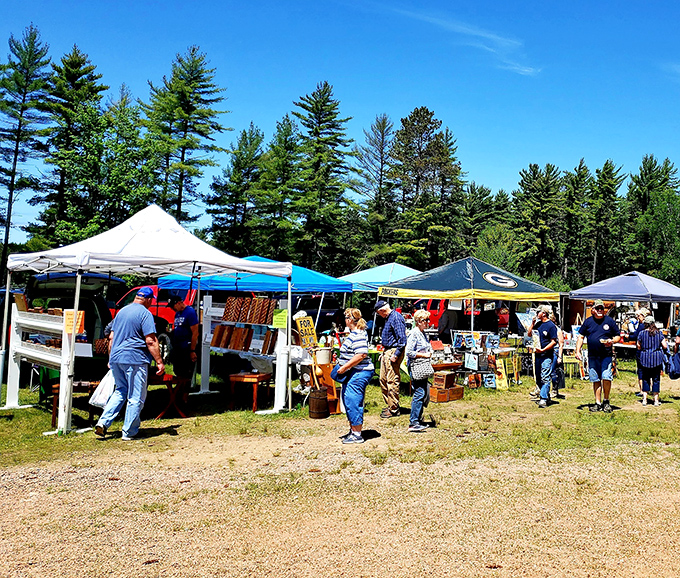 Pine trees frame this northwoods marketplace where nature meets the art of deal-making.