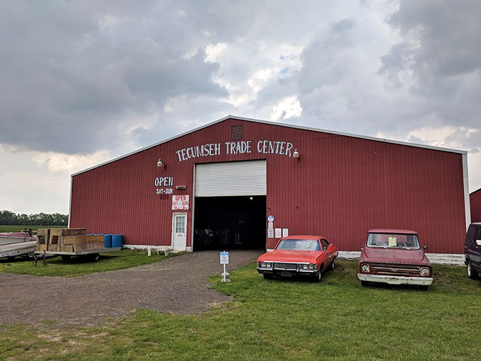 The big red barn of Tecumseh Trade Center stands like a beacon for treasure hunters, complete with vintage cars setting the mood.