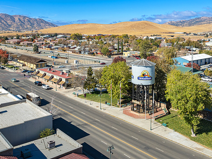 Tehachapi's downtown stretches beneath golden hills dotted with modern wind-powered sentinels spinning lazily.