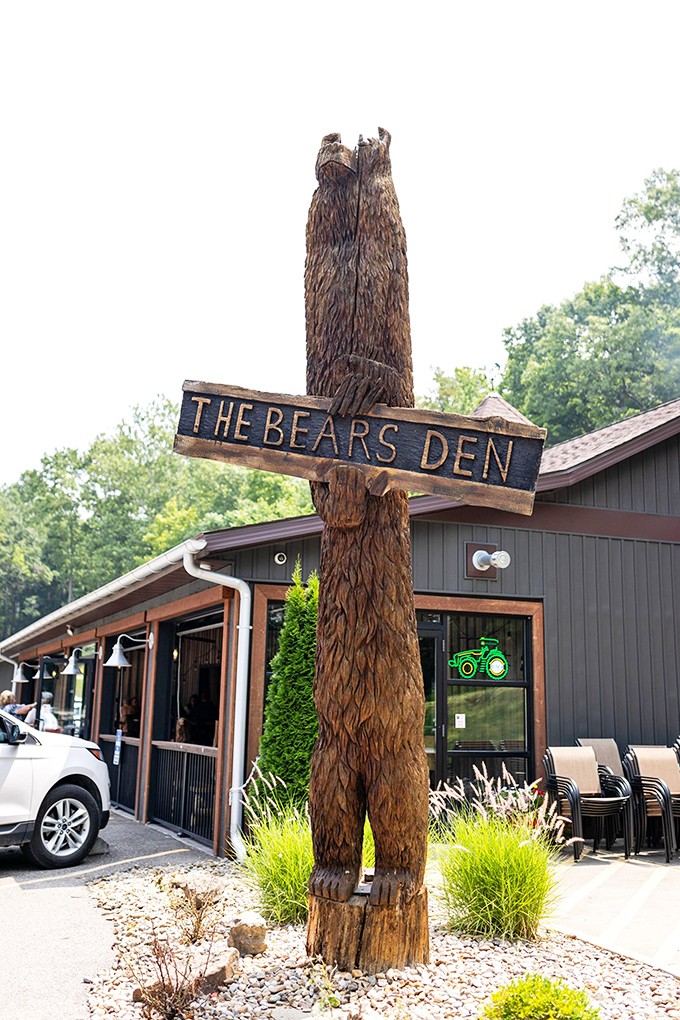 Nothing says "authentic steakhouse experience" quite like a hand-carved wooden bear welcoming you to carnivorous paradise and rustic charm.