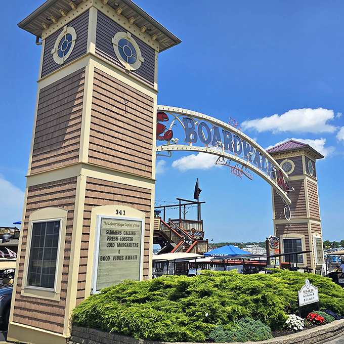 Grand entrance worthy of a maritime kingdom! The Boardwalk's twin lighthouse towers promise seafood treasures beyond the archway.