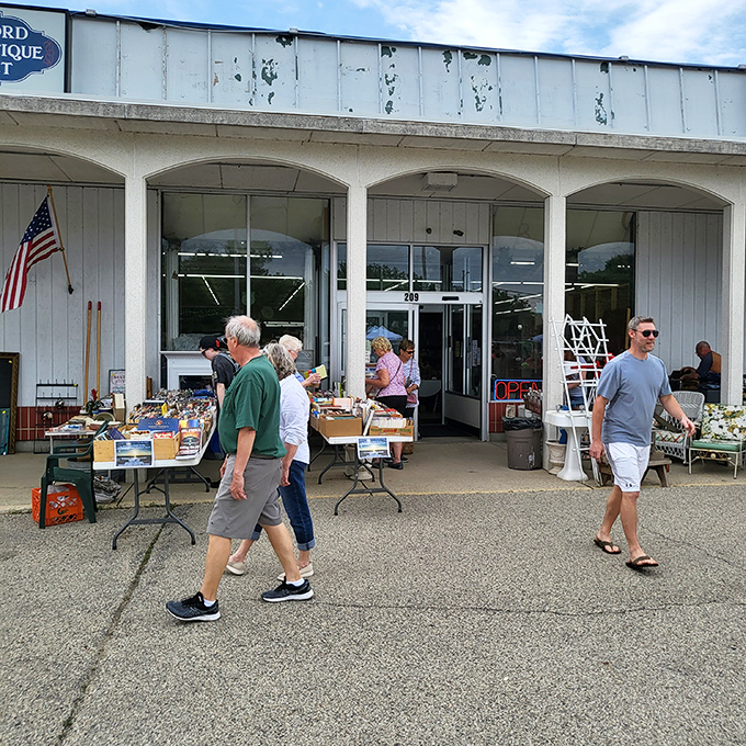 That classic white building with arched windows whispers promises of forgotten treasures and timeless finds.