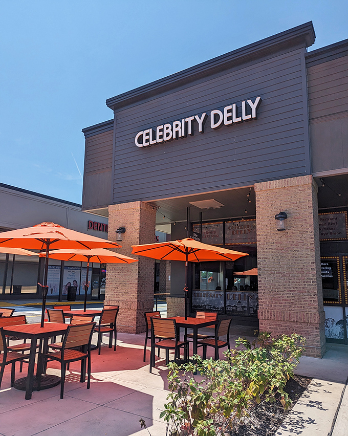 The modern brick facade of Celebrity Delly houses sandwich stardom. That patio is where lunch breaks turn into mini-holidays.
