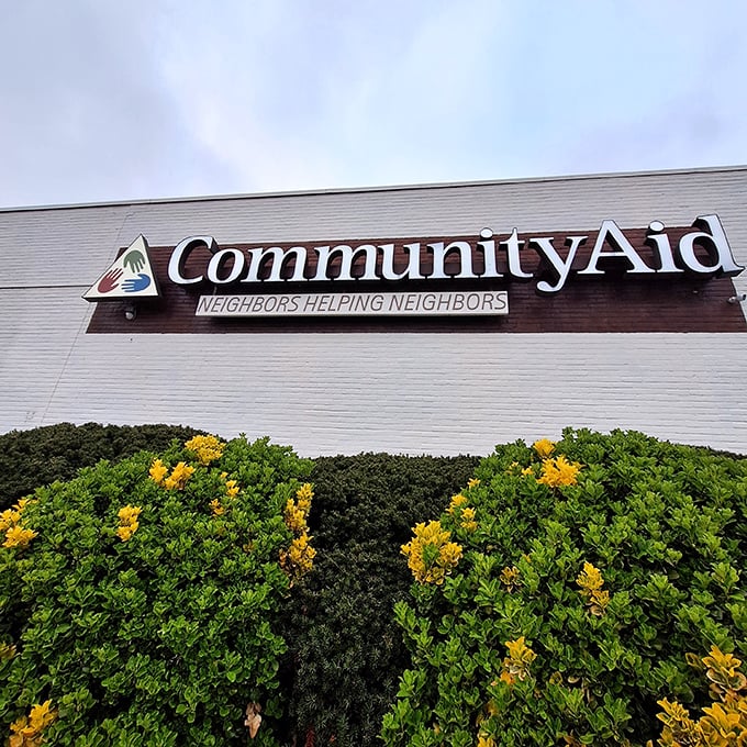 The "Neighbors Helping Neighbors" motto captures the heart of what makes thrift shopping feel so wonderfully communal.