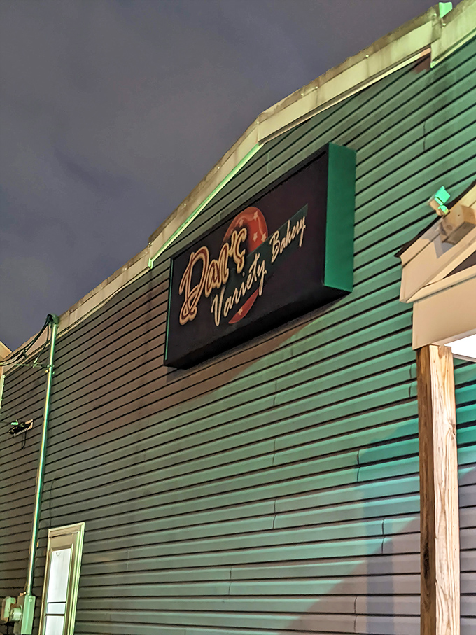 Night falls, but Dan's neon sign glows like a beacon for donut lovers. The bat signal for those with a sweet tooth.