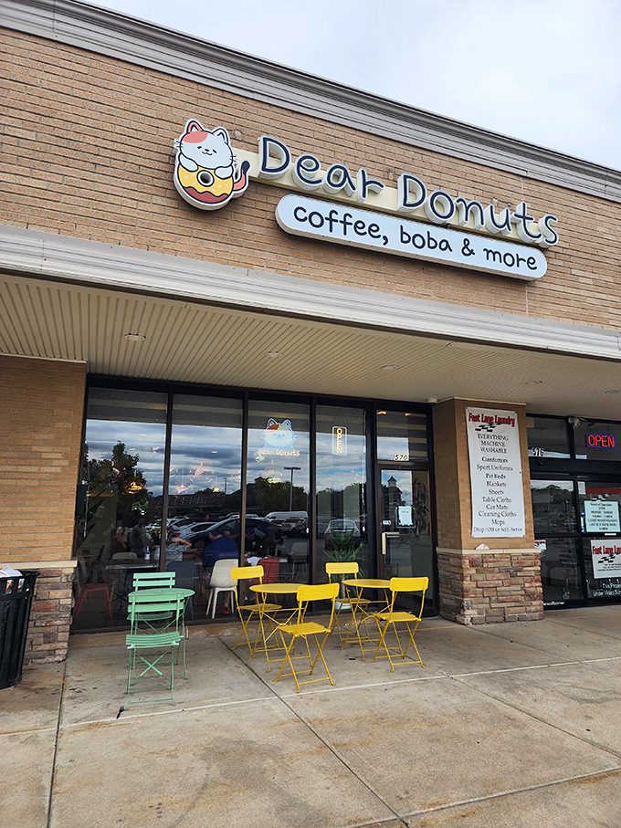 Colorful outdoor seating at Dear Donuts invites you to linger over your sweet treats. That cat logo is almost too cute to eat... almost.