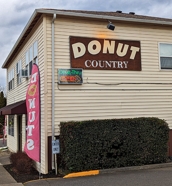 The "Drive-Thru Open" sign at Donut Country promises quick access to freshly-made delights for busy morning commuters.