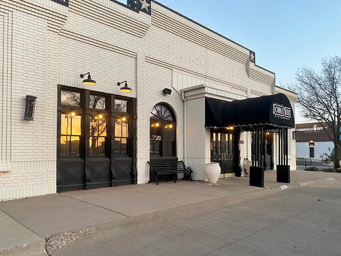 Classic black awnings frame the entrance to steak paradise. Double Nickel's understated exterior is like a secret handshake among beef connoisseurs.