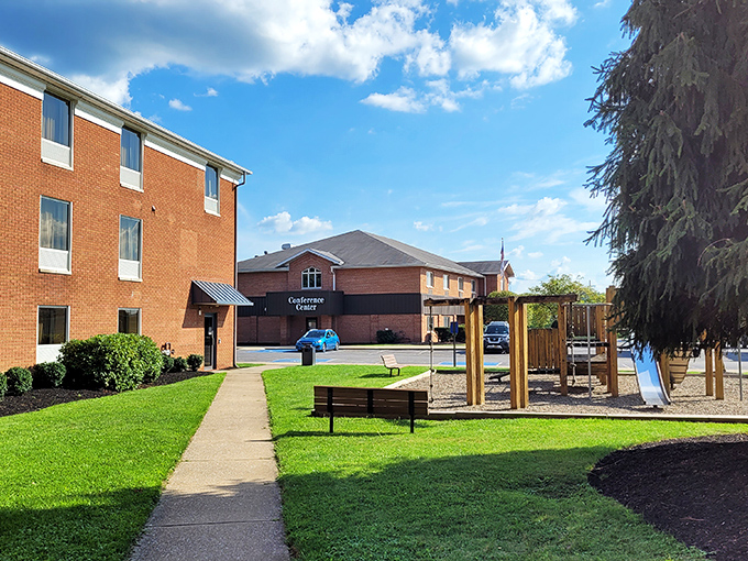 A quiet corner of DuBois, where community life unfolds between red brick walls and open green spaces.