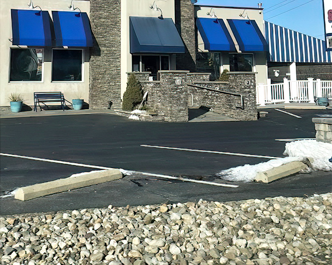 Blue awnings beckon like ocean waves, promising fresh catches prepared with time-honored techniques and modern flair.