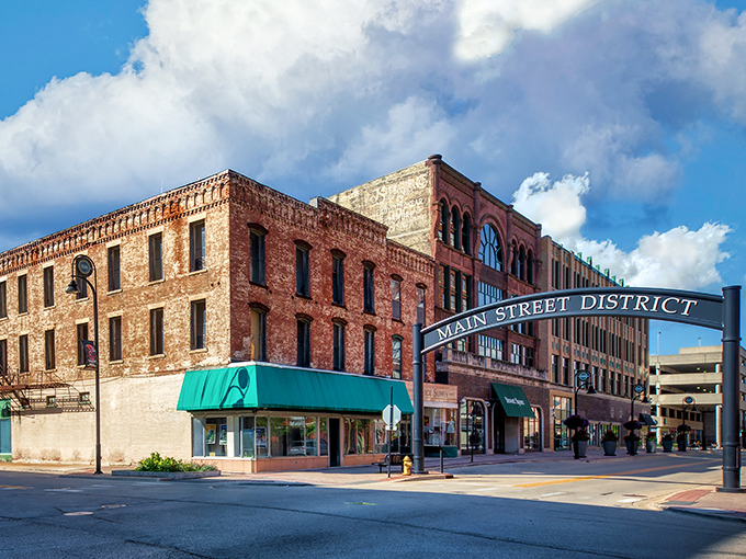 The "Main Street District" sign welcomes visitors to Rockford's downtown, where historic buildings house local businesses near budget-friendly neighborhoods.