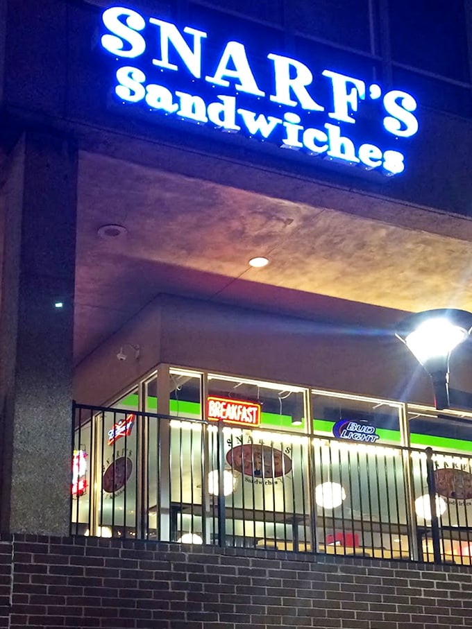 That glowing sign beckons like a lighthouse for hungry souls navigating the urban lunch landscape.