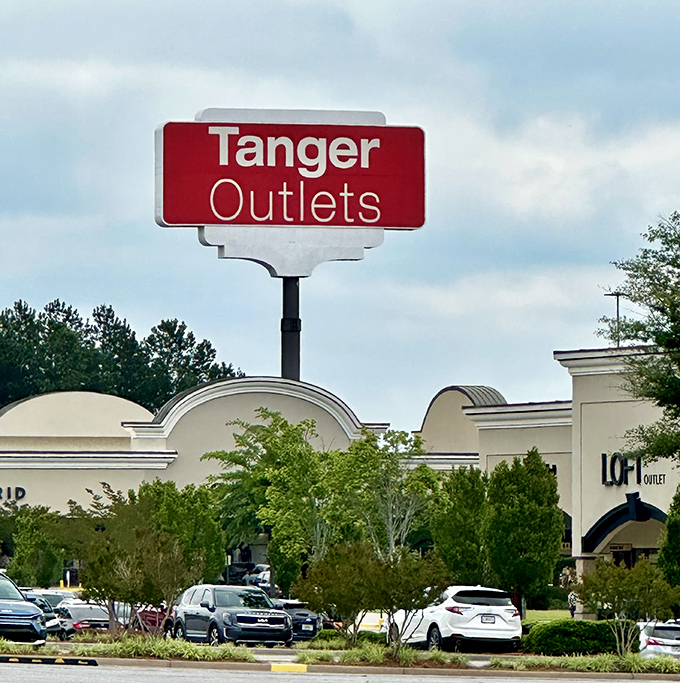 That red Tanger sign beckons like a lighthouse guiding ships to safe harbor, except the treasure here is designer discounts.