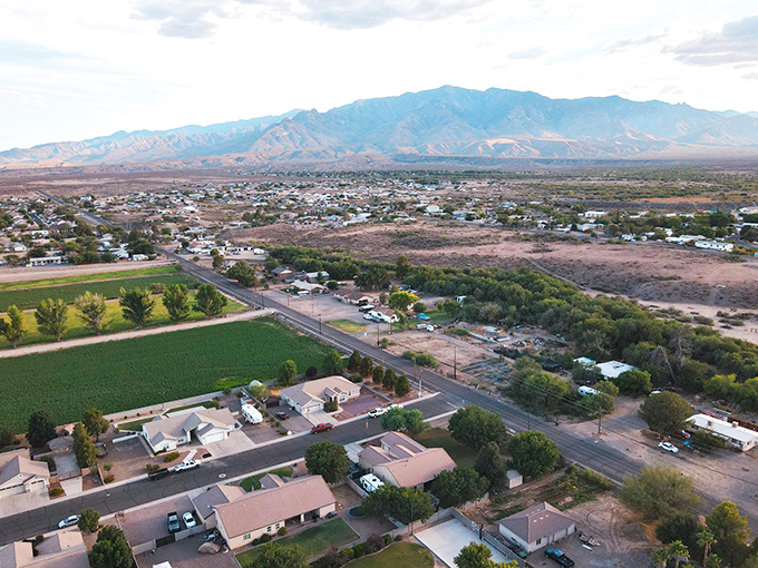 From above, Thatcher reveals its secret weapon: lush agricultural abundance that keeps grocery prices down and spirits up against that mountain backdrop.
