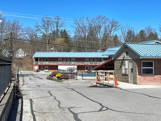 The classic motel with its blue roof offers a nostalgic reminder of road trips before GPS and online reviews existed.