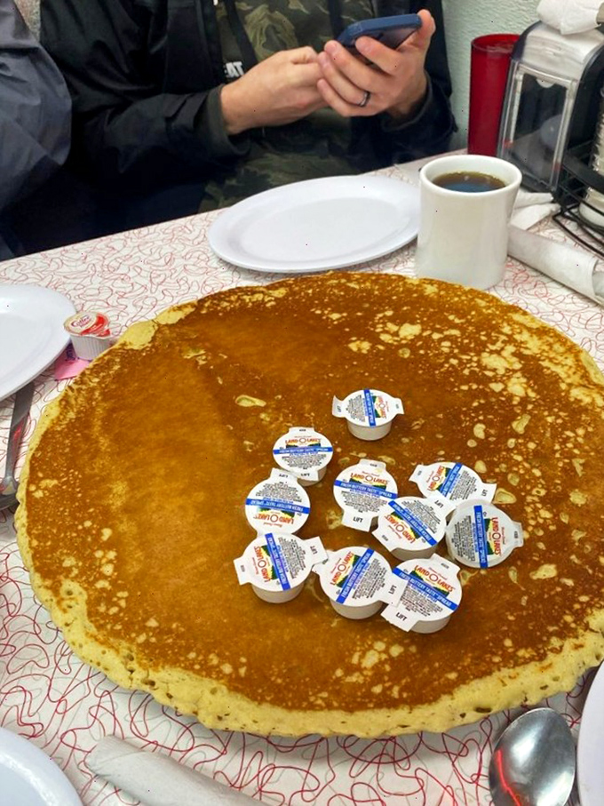 The legendary 16-inch pancake doesn't just feed you&mdash;it dares you. Those cream containers aren't garnish; they're ammunition for the sweet battle ahead.