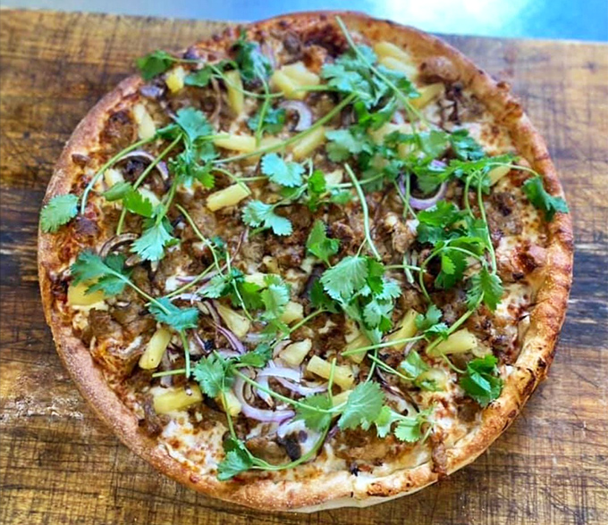 Fresh cilantro and pineapple dance atop this pizza like they're celebrating the marriage of sweet and savory &ndash; a fiesta on flatbread.