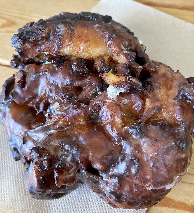 The apple fritter &ndash; a magnificent, craggly landscape of caramelized apple chunks and cinnamon valleys, glazed to glistening perfection. Worth every calorie.
