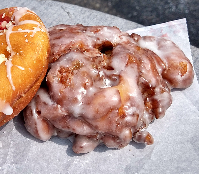 The apple fritter&mdash;that magnificent, irregular masterpiece of fried dough&mdash;glistening with glaze and promising cinnamon-apple bliss in every bite.