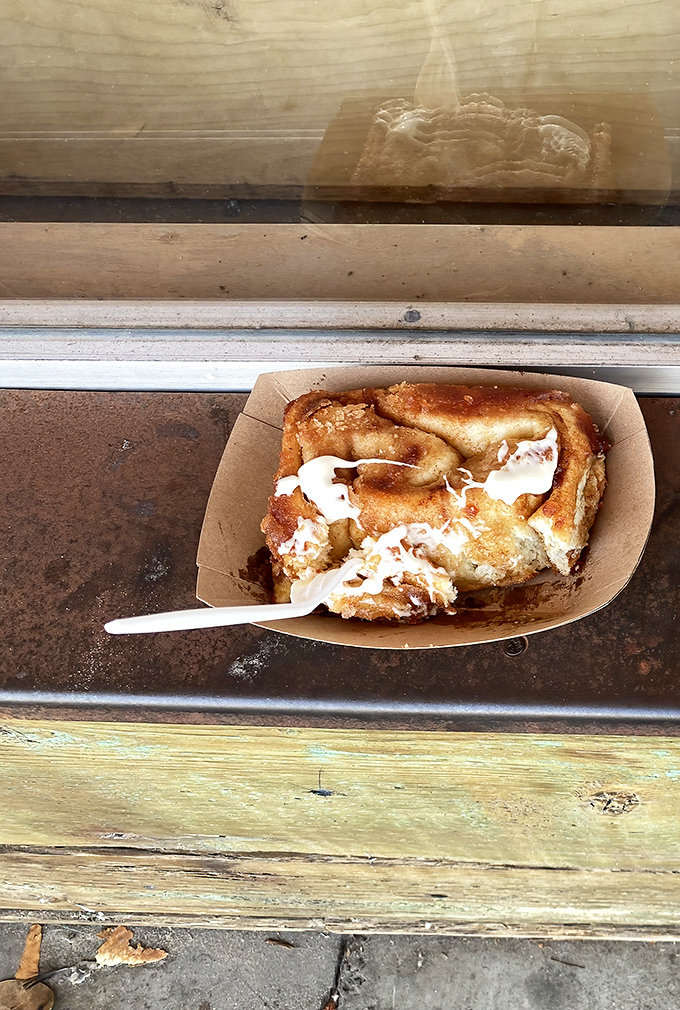 The frosted roll, caught in its natural state before being devoured. That cream cheese frosting melting into warm dough is what breakfast dreams are made of.