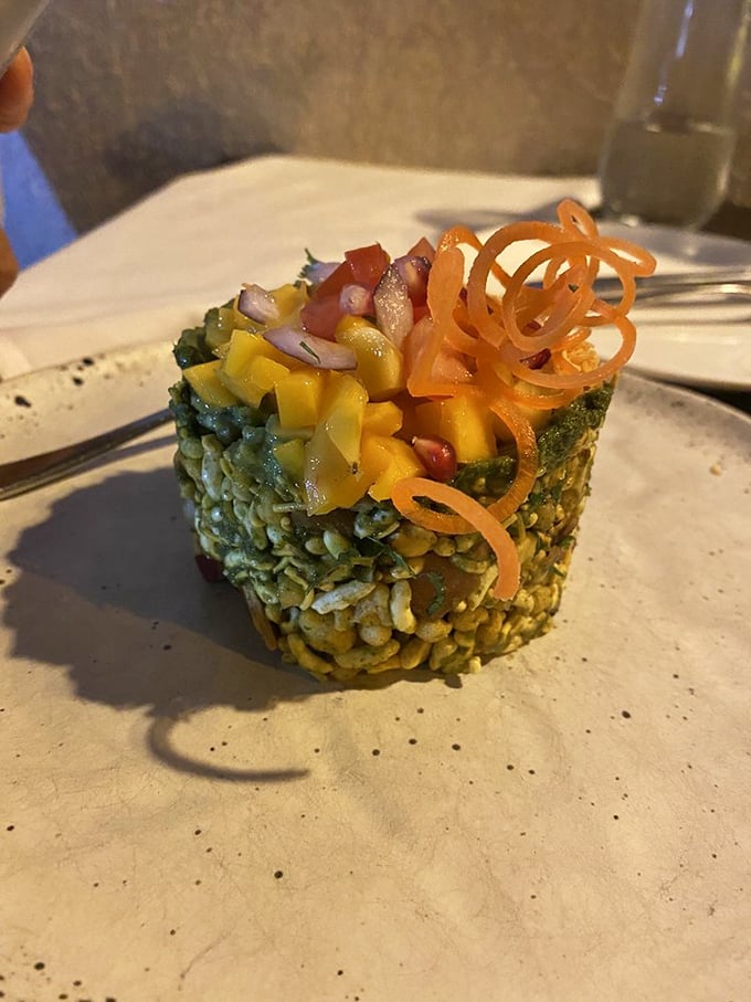 The Avocado Mango Bhel is architectural genius on a plate&mdash;crispy puffed rice supporting sweet mango and creamy avocado, crowned with spirals of carrot that add both color and crunch.