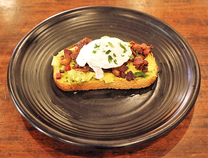 Avocado toast elevated to art form &ndash; creamy, colorful, and crowned with perfectly poached egg sunshine.