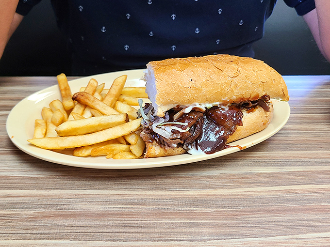 This isn't just a sandwich; it's a masterclass in comfort&mdash;tender BBQ beef nestled in French bread with crispy fries standing at attention.