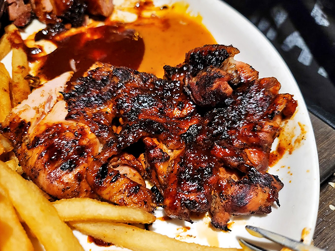 Blackened, beautiful, and beckoning—this brick chicken has clearly graduated with honors from the School of Perfect Char and Juicy Interiors.