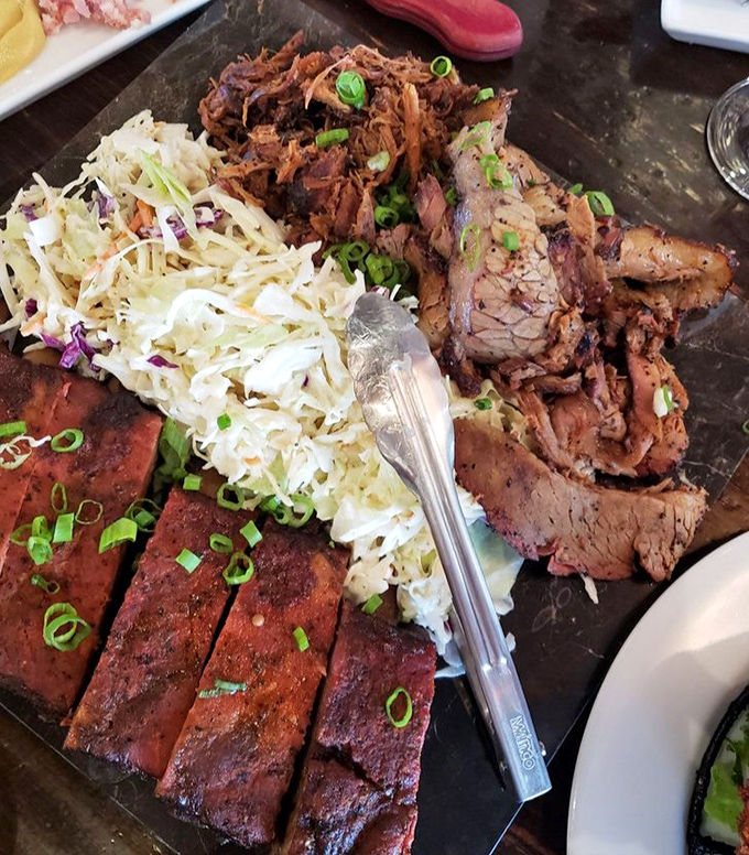 The BBQ platter arrives like a carnivore's dream team&mdash;ribs, brisket, and pulled pork flanked by cooling coleslaw, ready for your undivided attention.