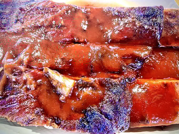 Ribs with that perfect mahogany sheen that makes you want to skip the fork altogether. Napkins are not optional here.