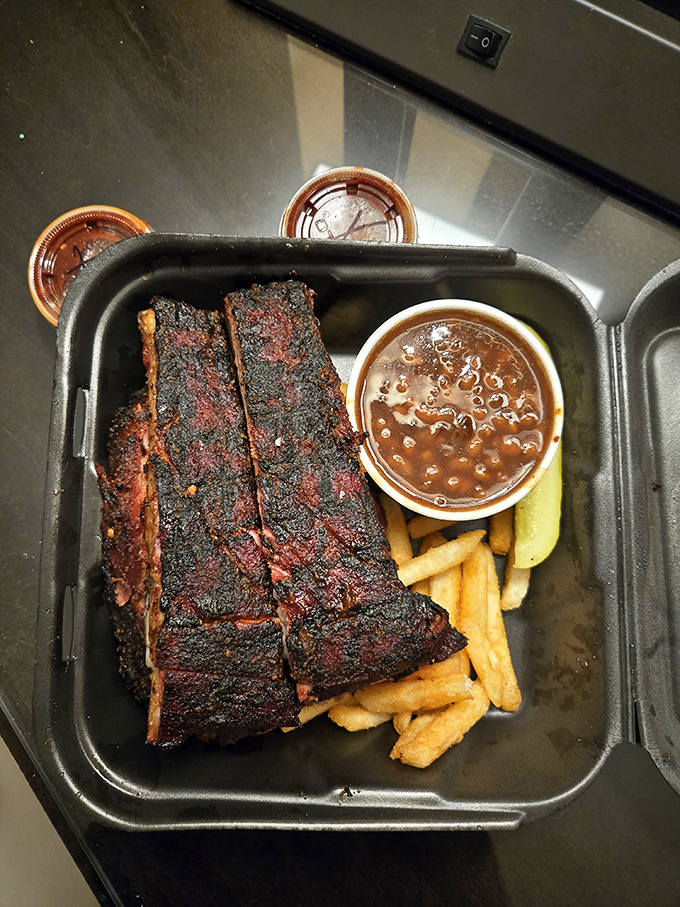 These ribs aren't just falling off the bone&mdash;they're practically volunteering to jump onto your plate. Paired with beans and fries, it's comfort food nirvana.