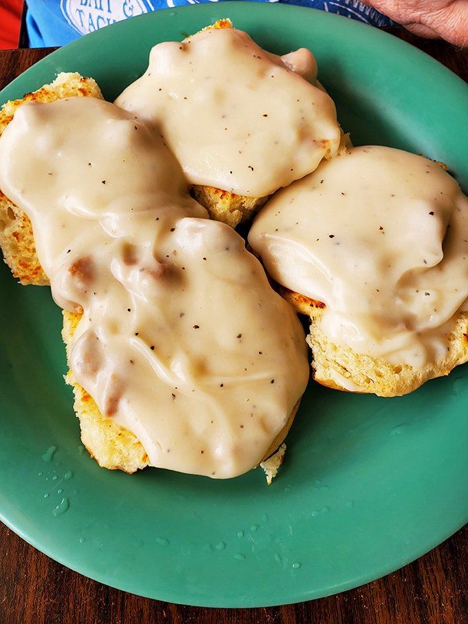 Biscuits and gravy that would make your Southern grandmother weep with joy – pillowy foundations smothered in peppery, soul-warming gravy.
