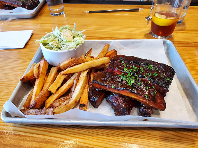 These ribs don't just fall off the bone—they practically leap onto your fork with a perfect bark that's the barbecue equivalent of a standing ovation.