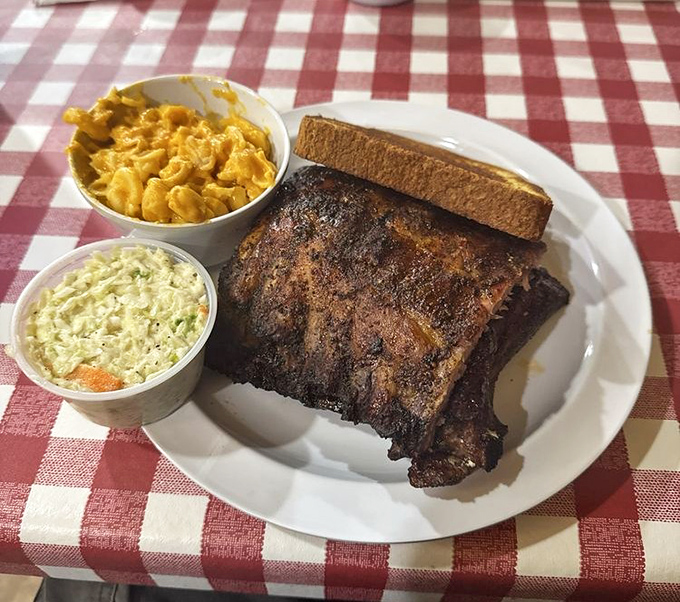 Baby back ribs with that perfect bark, flanked by creamy mac and cheese and coleslaw—a holy trinity of Southern comfort that makes diets weep with jealousy.