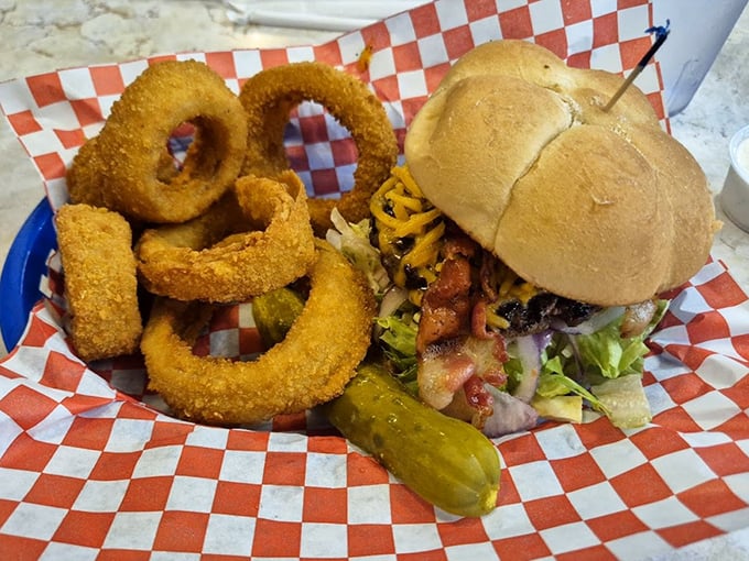 This burger and onion ring combo isn't just a meal, it's an edible American dream with a pickle on the side.