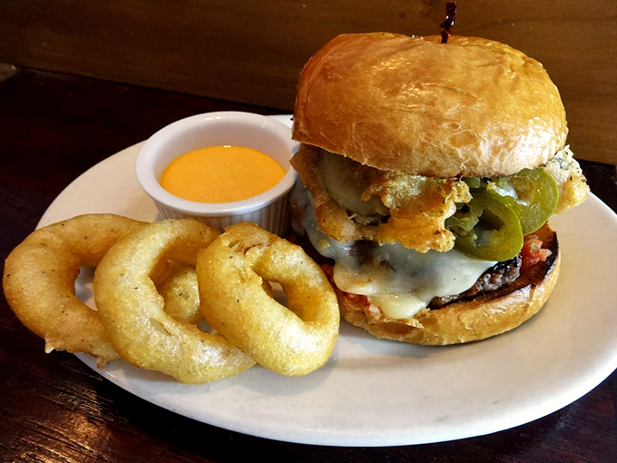 This isn't just a burger with onion rings &ndash; it's architectural genius with layers of flavor that would make Frank Gehry jealous.
